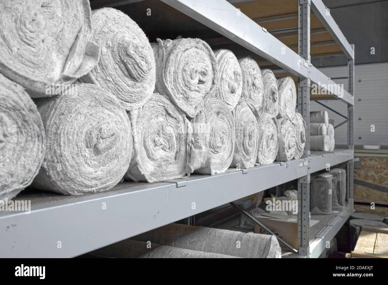 White material in rolls is on the shelves of the warehouse. Covering ...