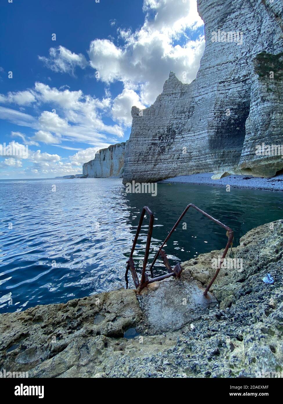 Ladder going down in the sea with on the background Limestone cliffs at ...