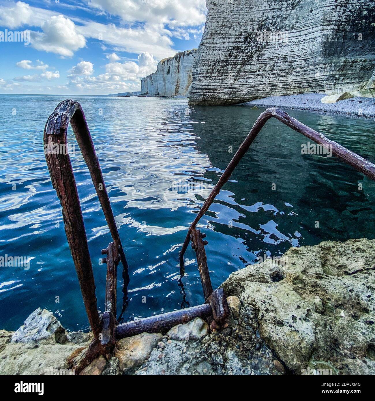 Ladder going down in the sea with on the background Limestone cliffs at ...