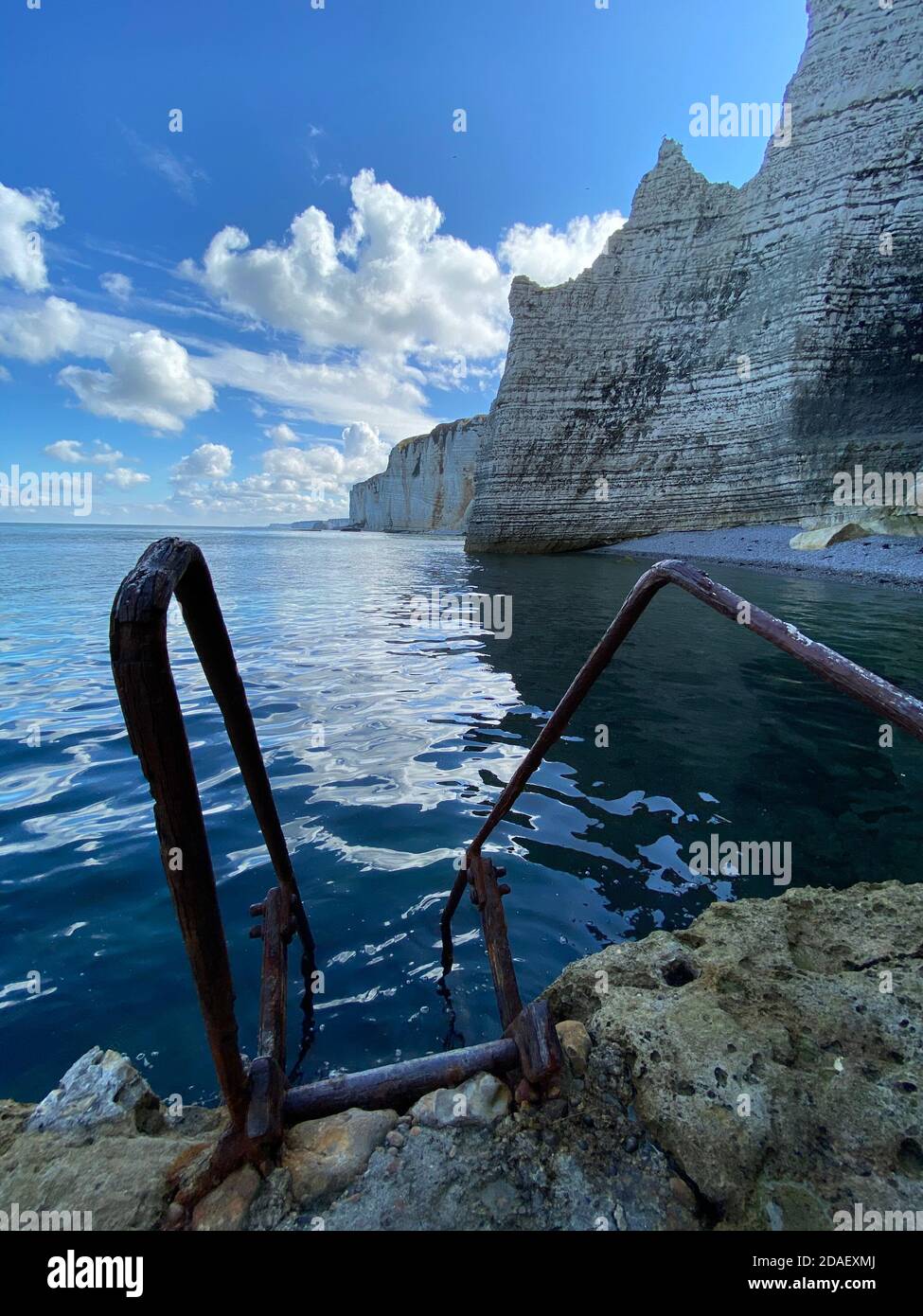 Ladder going down in the sea with on the background Limestone cliffs at ...