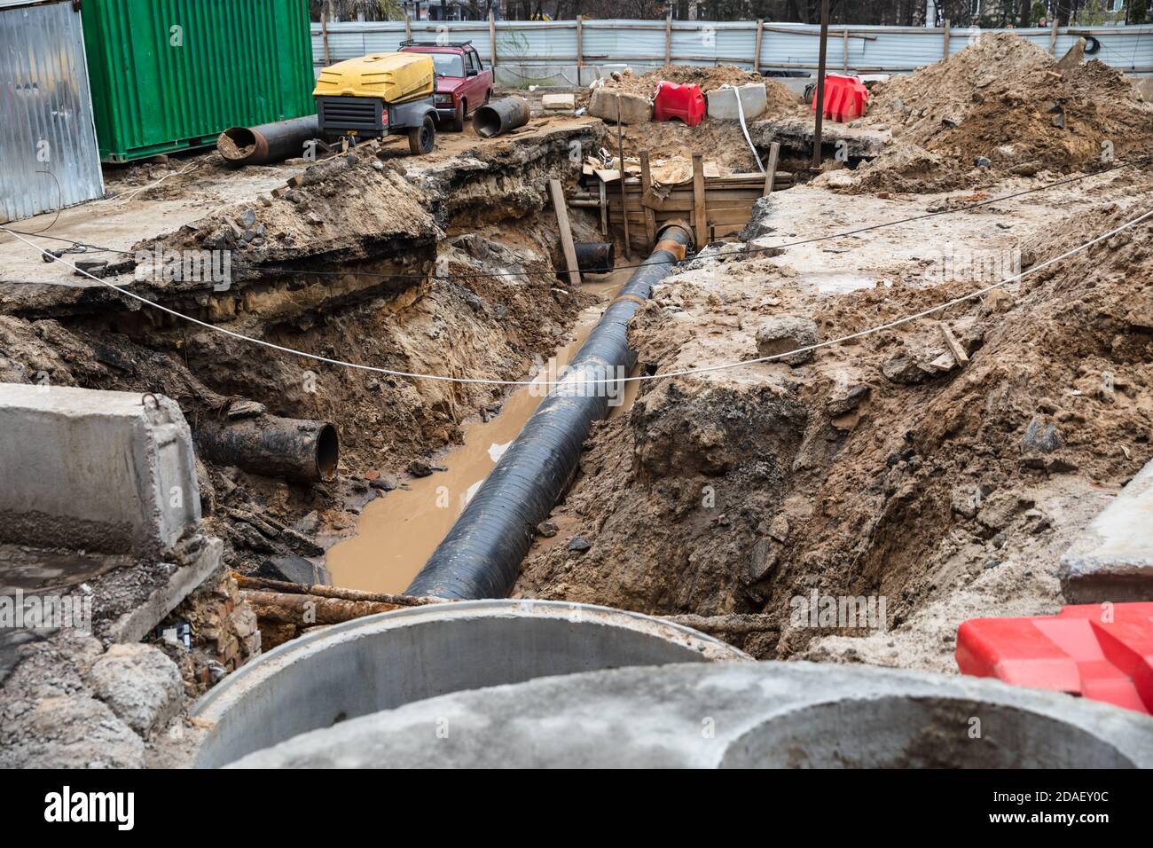 Repair of roads and underground utilities. Big trench on the road with ...