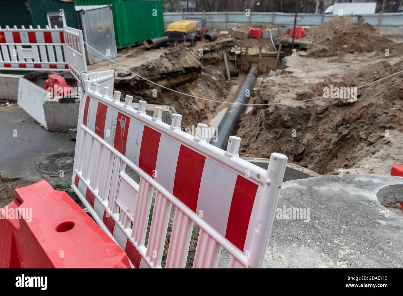 Repair of roads and underground utilities. Big trench on the road with ...