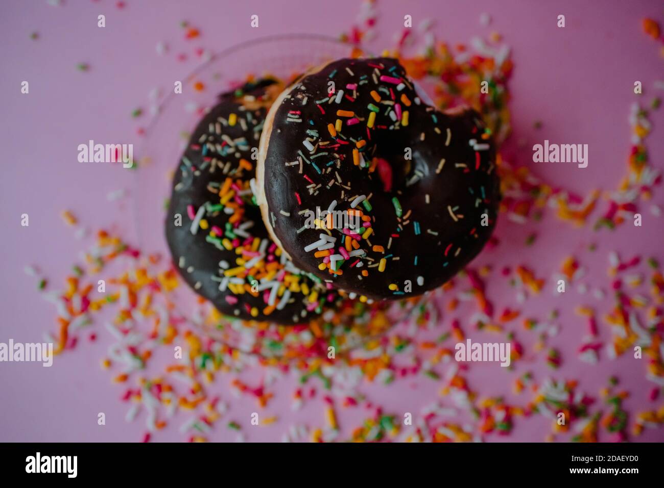 Top view of delicious chocolate donuts with sprinkles isolated on a ...