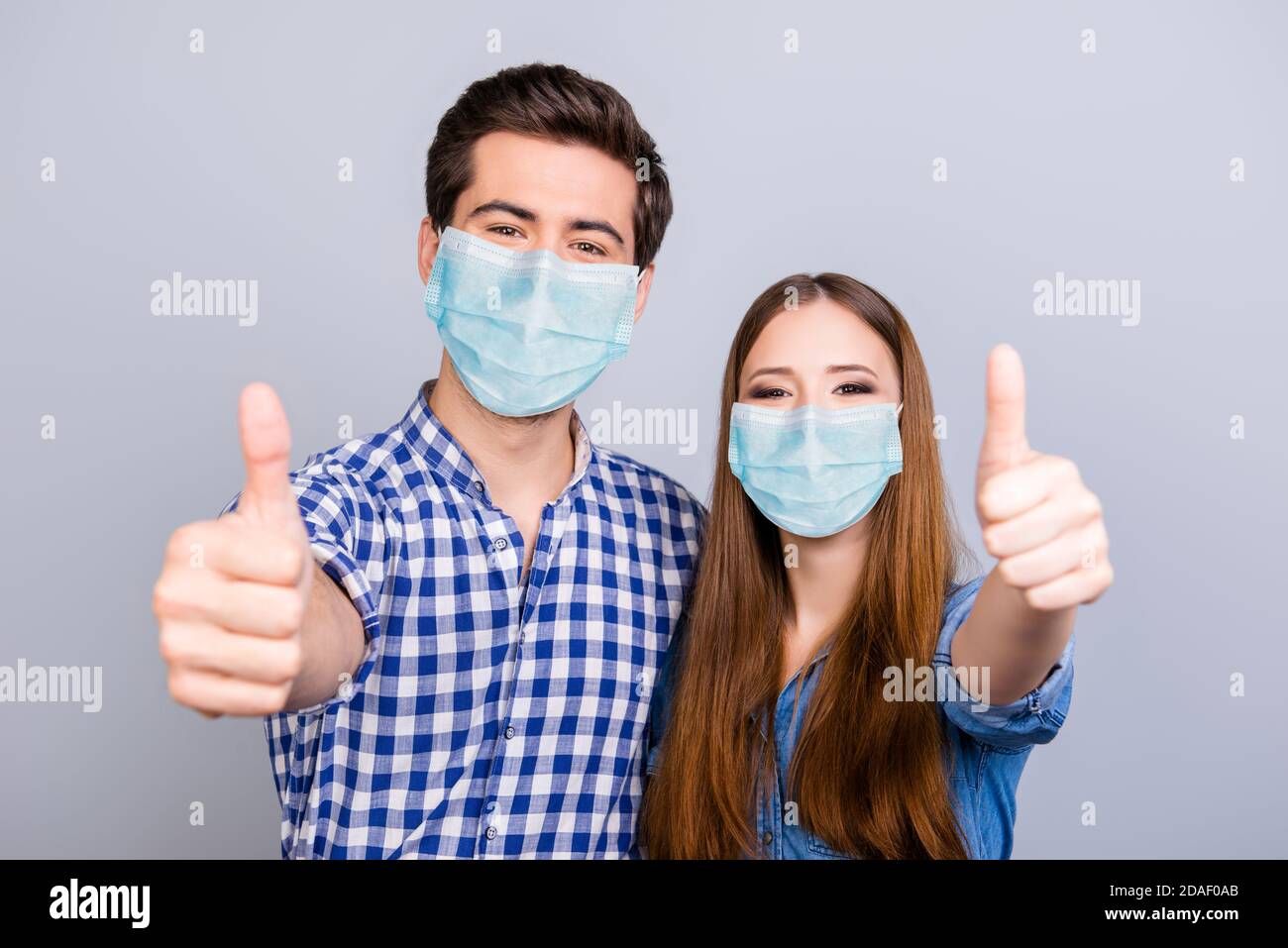 Photo portrait of brother and sister showing like signs wearing blue ...