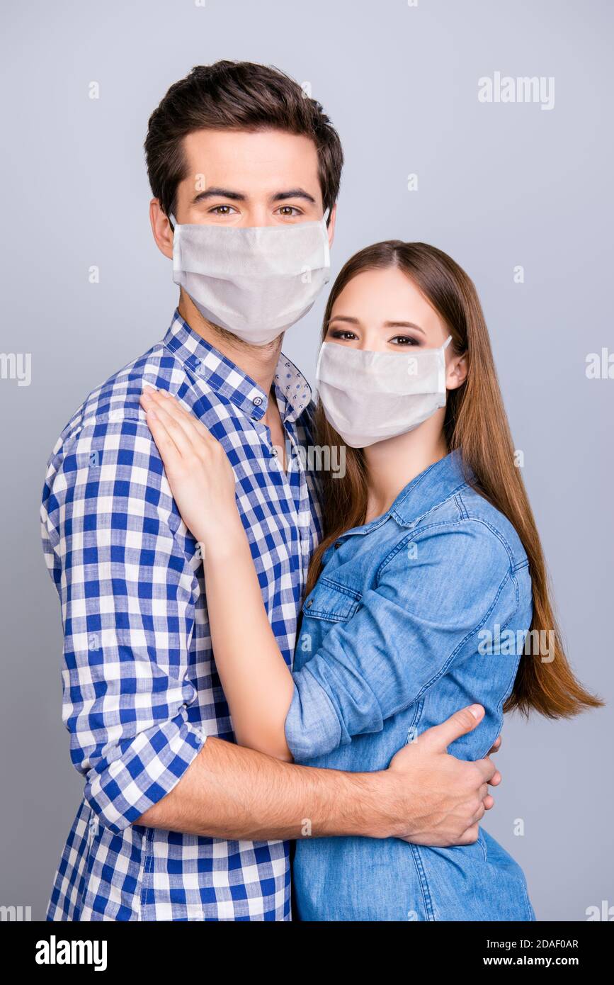 Vertical photo portrait of two young cute lovers hugging wearing white ...
