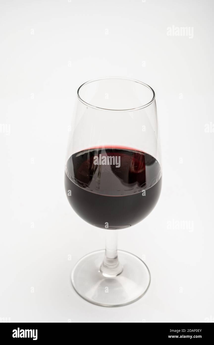 Glass of vintage ruby port wine isolated on white background close up ...
