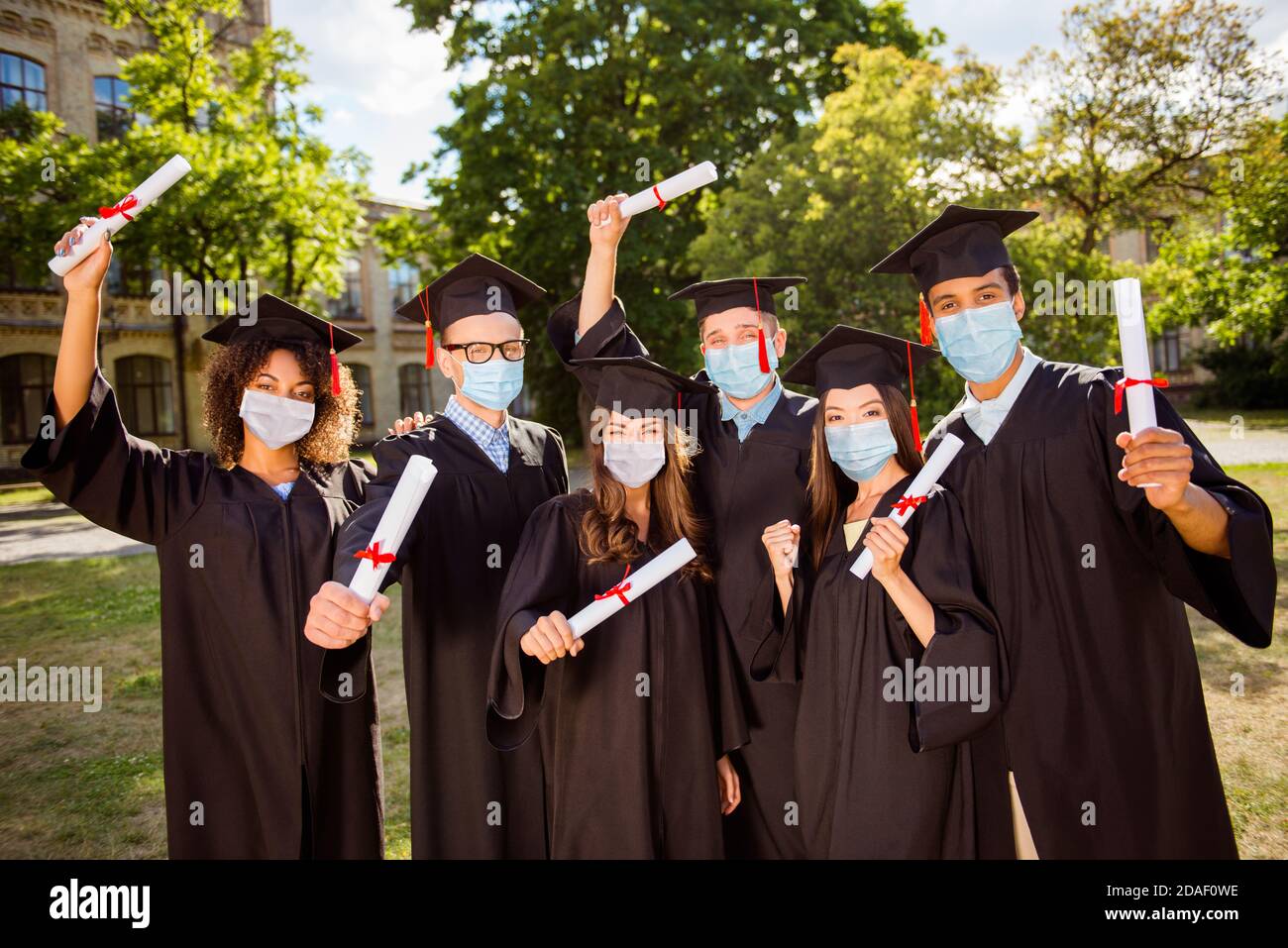 Photo portrait of six students celebrating graduation with diplomas in ...