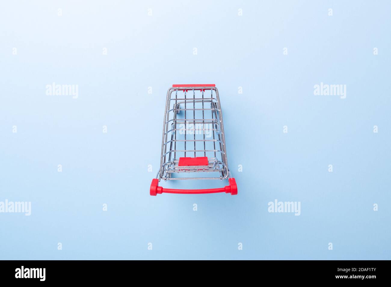 Mini trolley cart copy on blue background Top view Copy space - Image ...