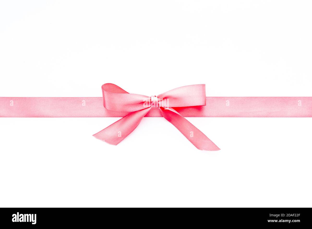 Pink ribbon with bow isolated on white. Top view, copy space Stock ...