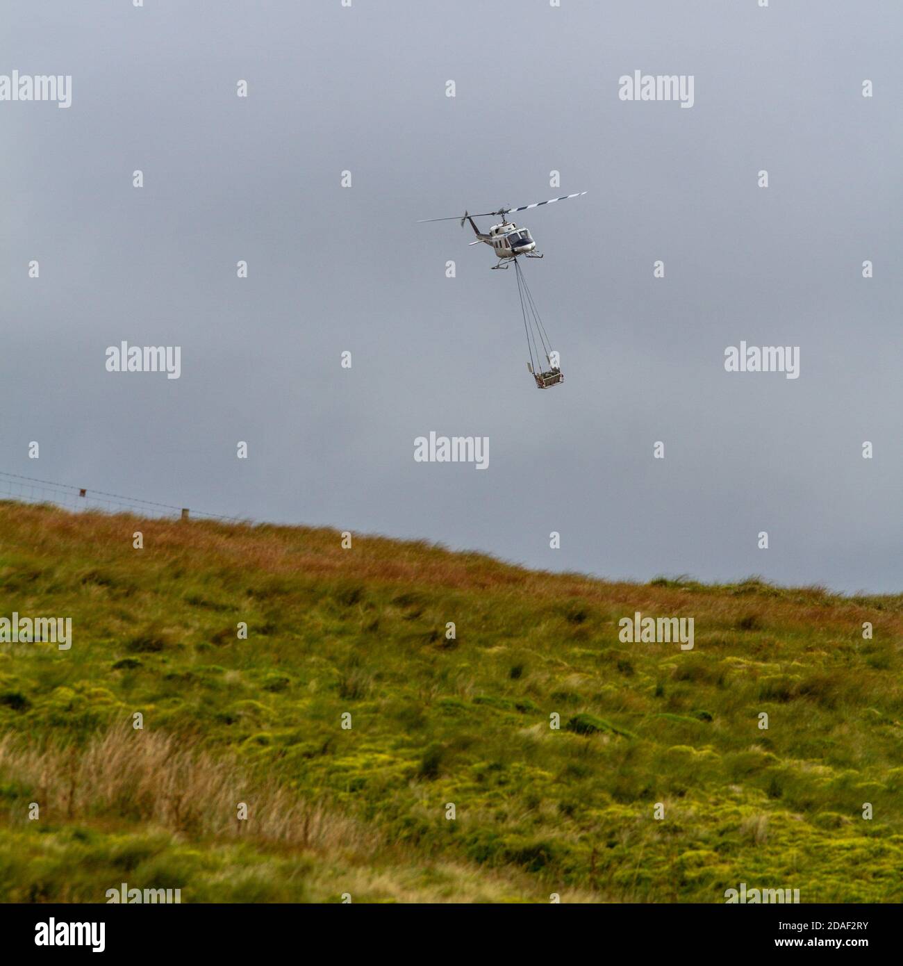 Helicopter carrying cargo - a sling with building materials for ground ...