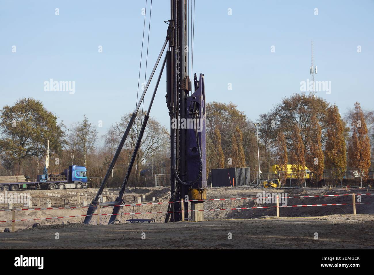 A pile driver drives a concrete pile into the ground at a Dutch ...