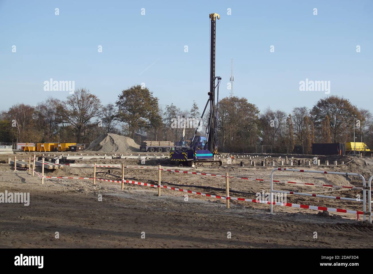 A pile driver drives a concrete pile into the ground at a Dutch ...