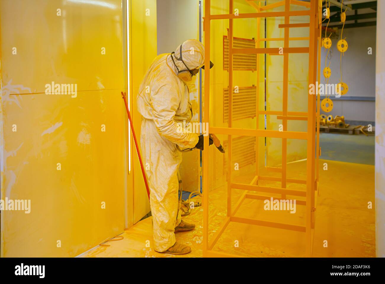 Construction worker spraying paint to steel pipe to prevent the rust on ...