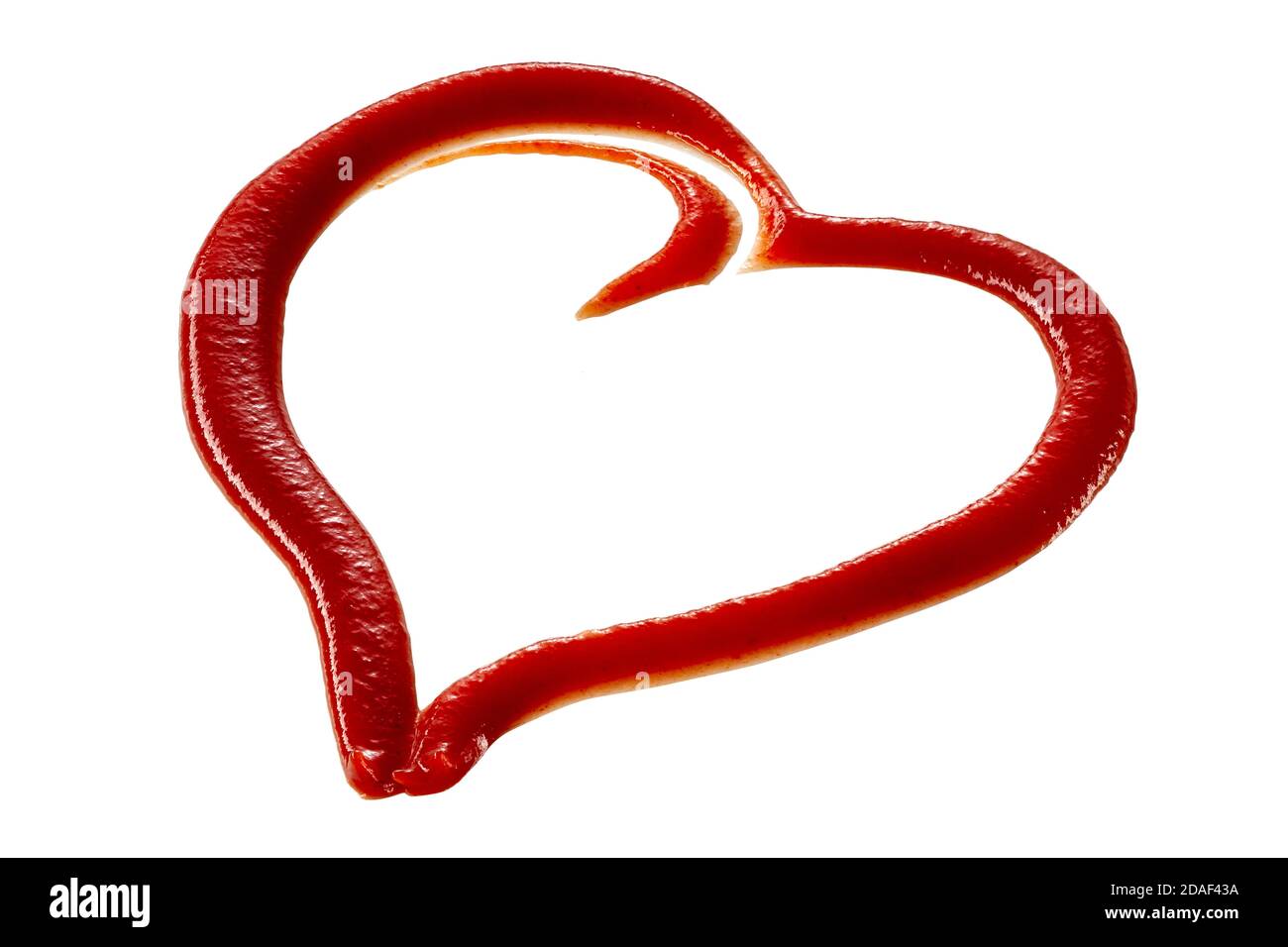 Heart shaped drizzle of tomato ketchup on white with central copyspace ...