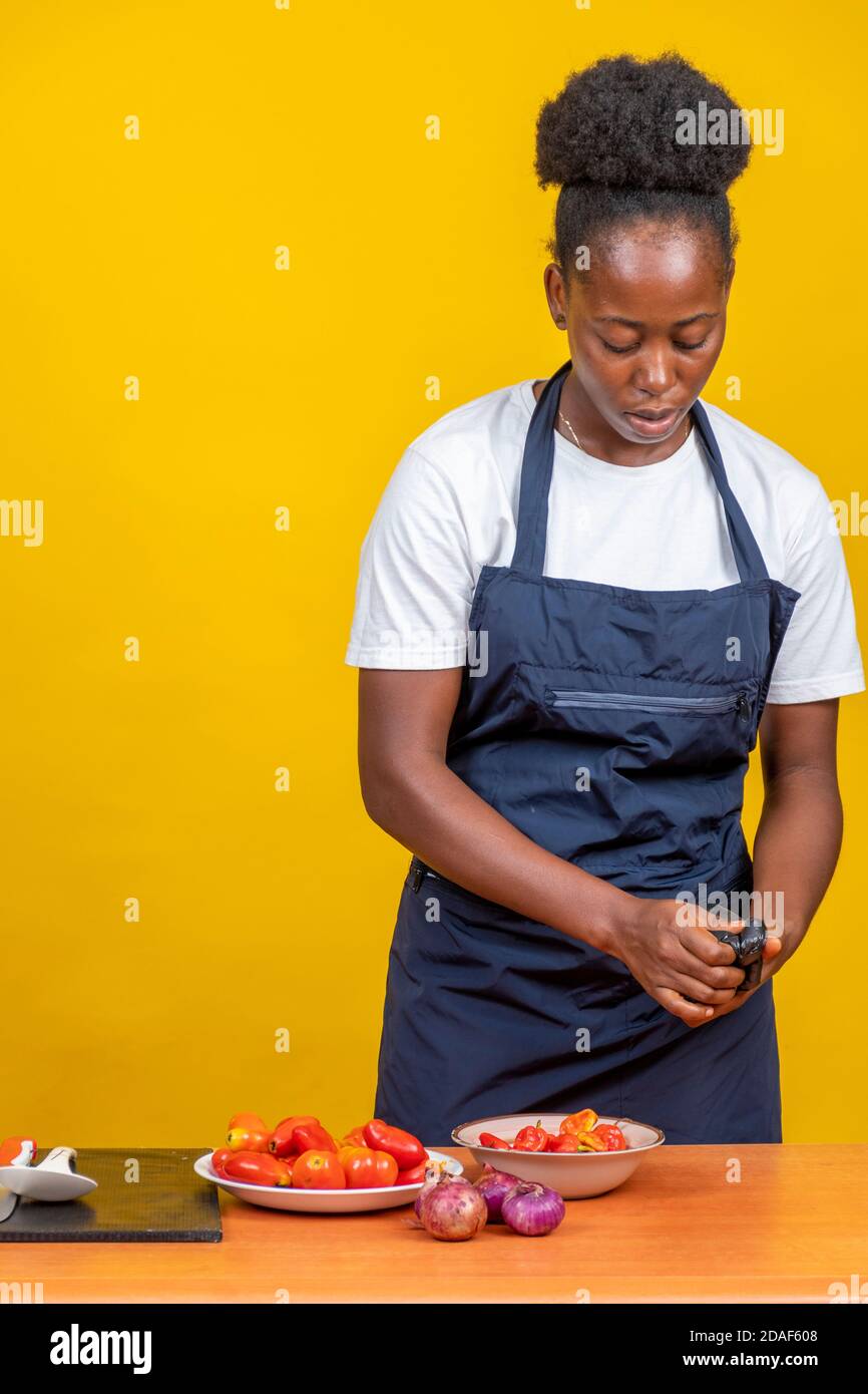 portrait of an african lady chef sorting out her ingredients to cook ...