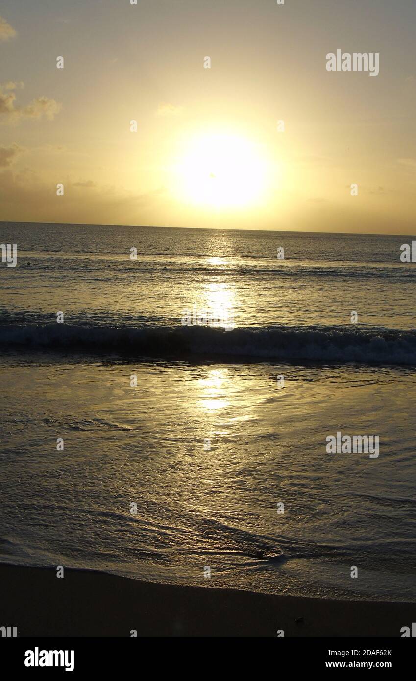 Portrait view of sun setting over sea. Waves rippling. Antigua Stock ...
