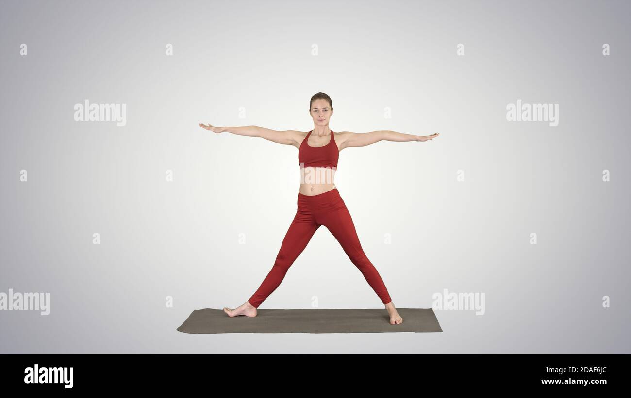 Woman practicing yoga, standing in Extended Side Angle exercise Stock ...
