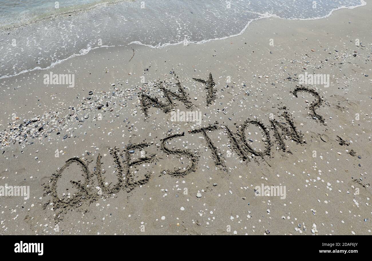 ANY QUESTION text written on the sand of the beach by the sea Stock ...