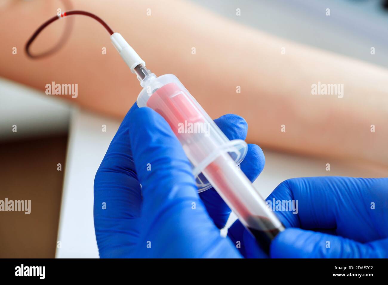 Hands of a doctor taking blood samples using a tube holder Stock Photo ...