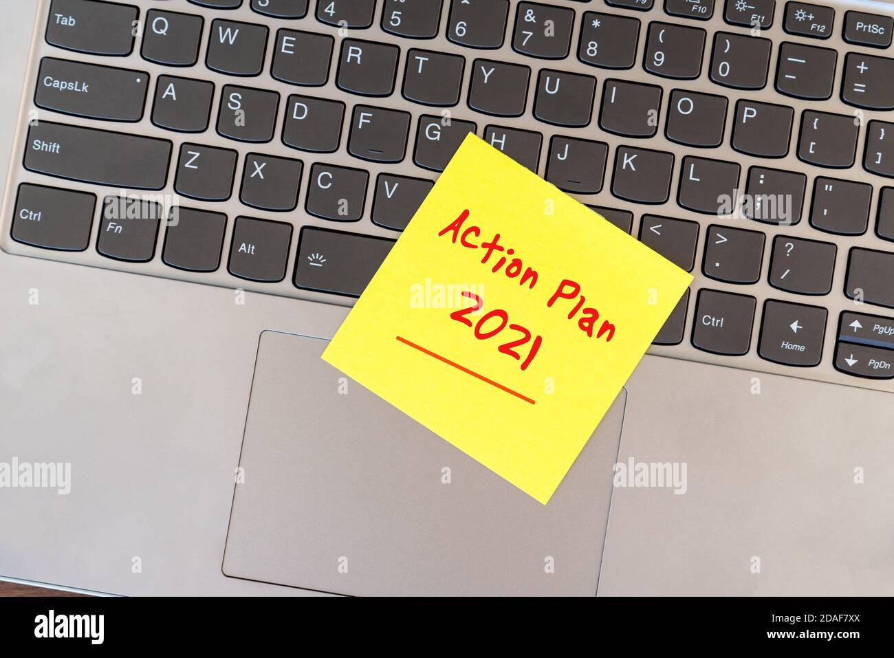 Action plan 2021 on yellow adhesive yellow paper note on top of laptop ...