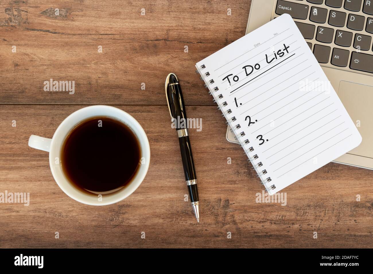 To do list text on notepad on top of laptop with cup of coffee and pen ...