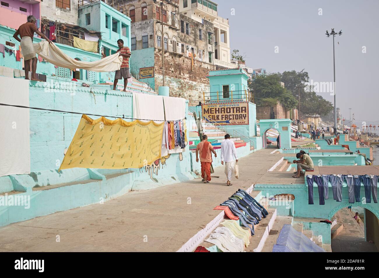 Varanasi, India, December 2015. Men putting clothes to dry in a ghat on ...