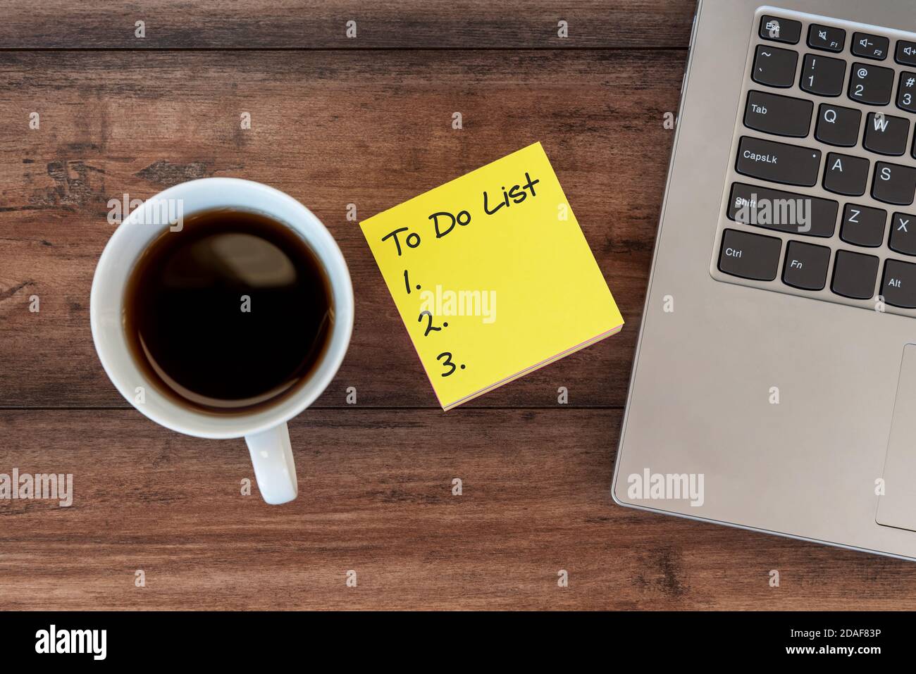 To do list text on adhesive paper note with laptop and cup of coffee ...