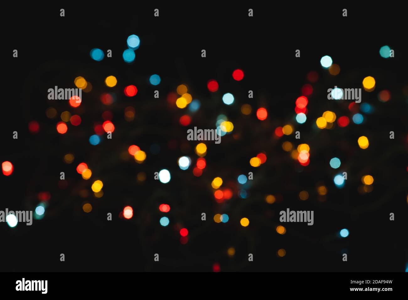 Multicolored spots of light against black background Stock Photo - Alamy