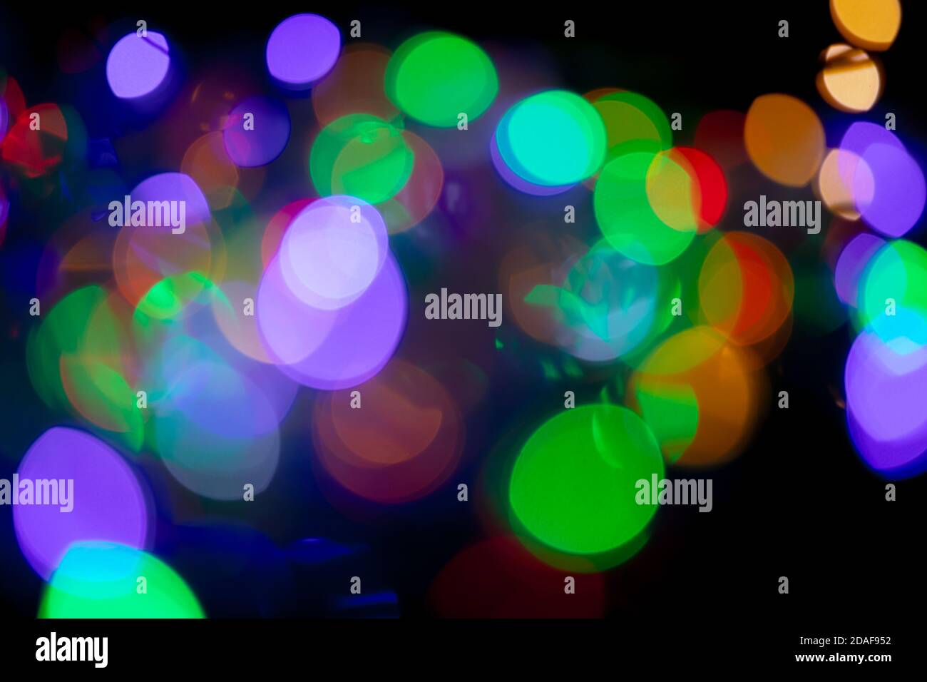 Multicolored spots of light against black background Stock Photo - Alamy