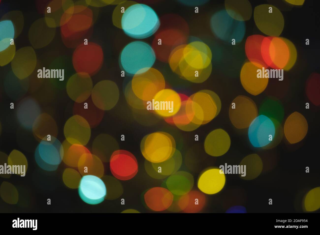 Multicolored spots of light against black background Stock Photo - Alamy
