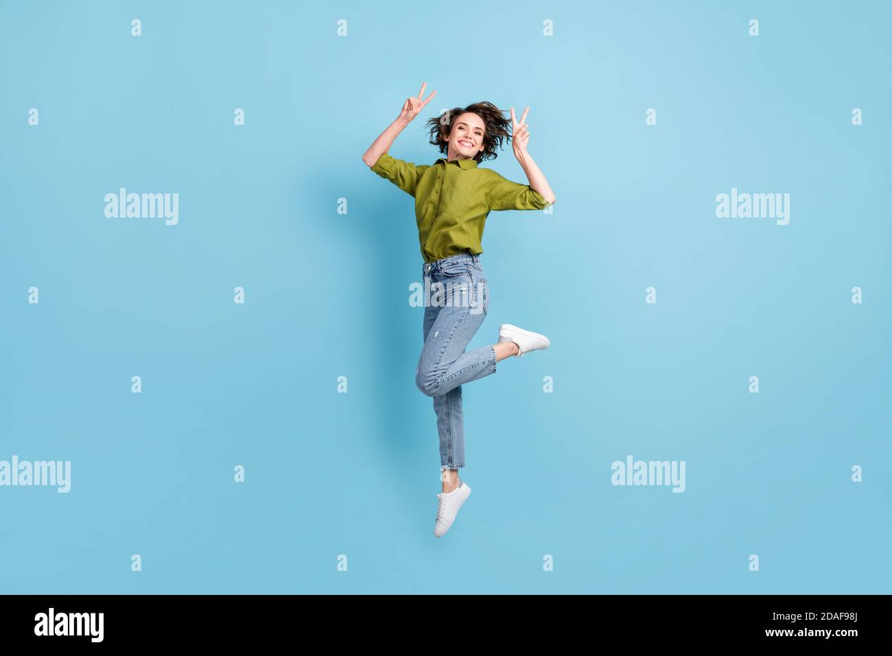 Photo portrait of woman jumping up showing two v-signs isolated on ...