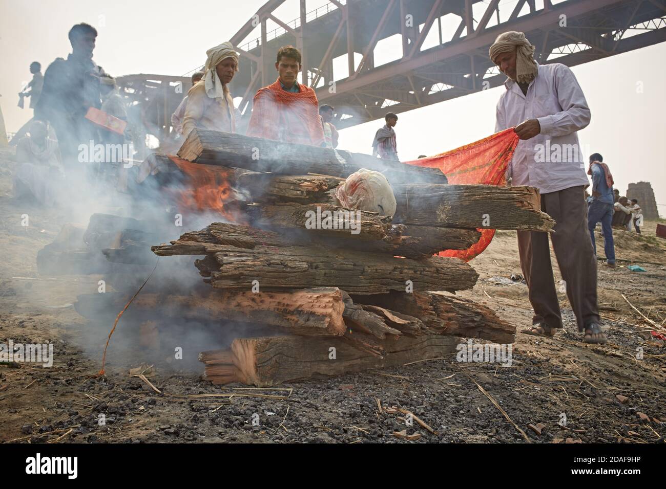 Varanasi, India, December 2015. Men prepare a funeral pyre near a ...