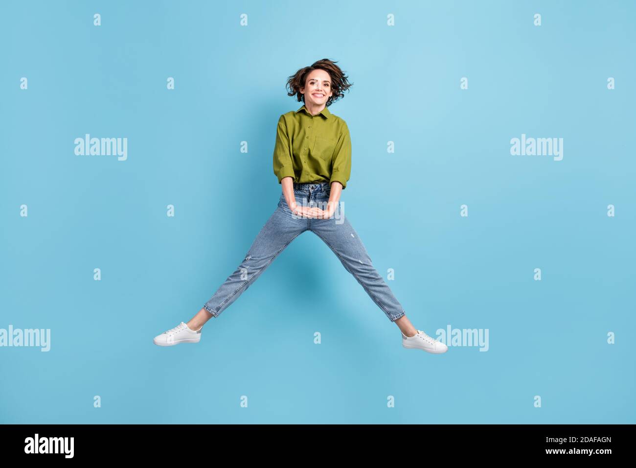 Photo portrait of woman jumping up spread legs isolated on pastel light ...
