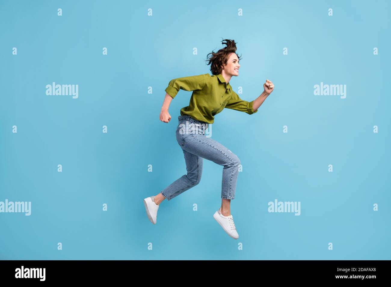 Photo portrait side view of woman running jumping up isolated on pastel ...