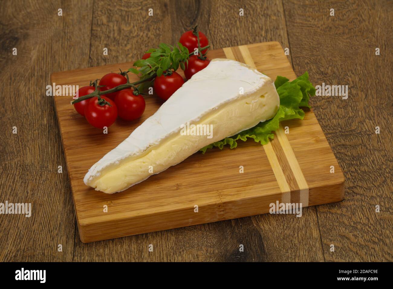 Brie cheese triangle served salad leaves Stock Photo - Alamy