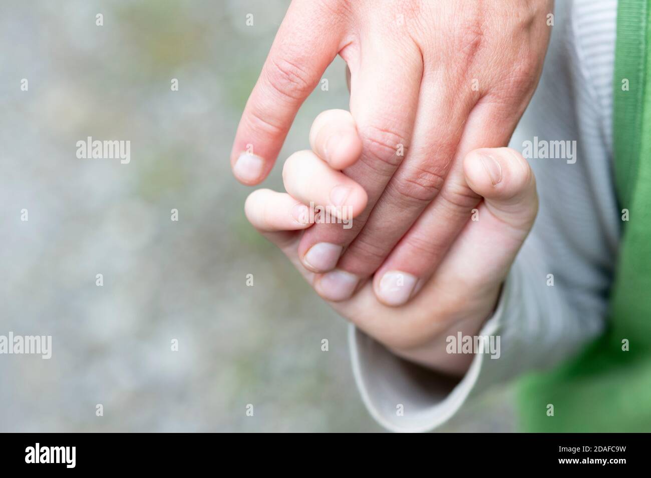 a child holds the hand of her mum Stock Photo - Alamy