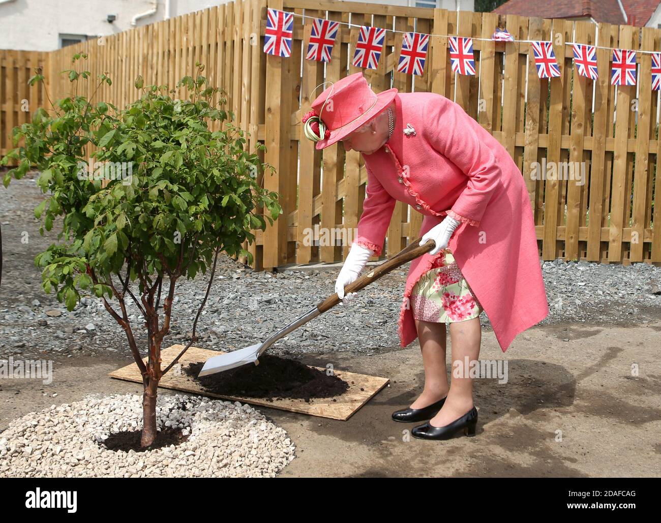 File photo dated 02/07/15 of Queen Elizabeth II planting a tree during ...
