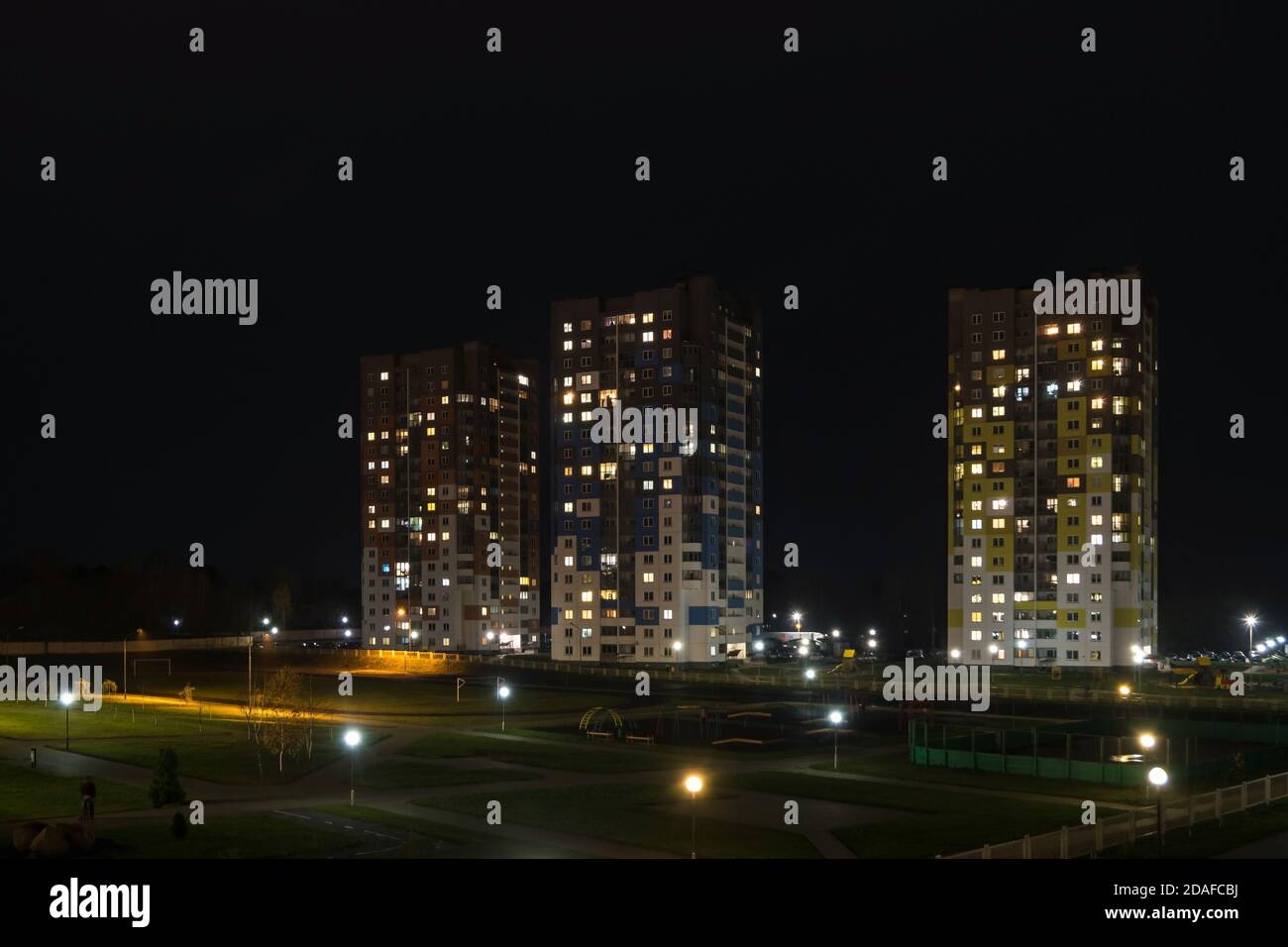 Night panorama of Light in the windows of a multistory building. life ...