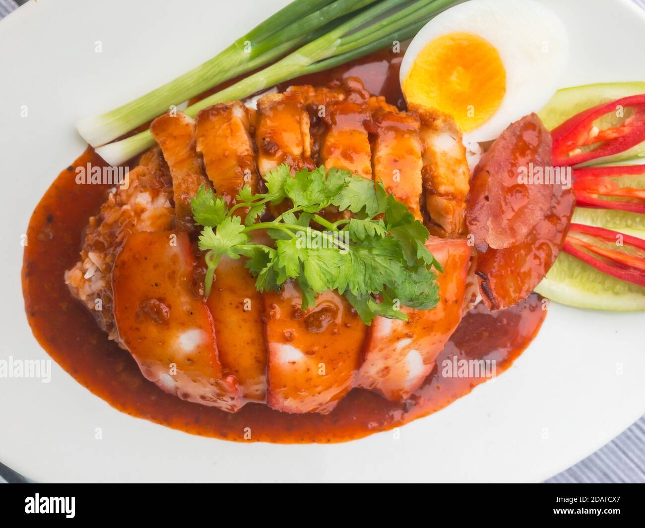 Red Crispy pork and Roasted Pork with red sauce on rice Stock Photo - Alamy
