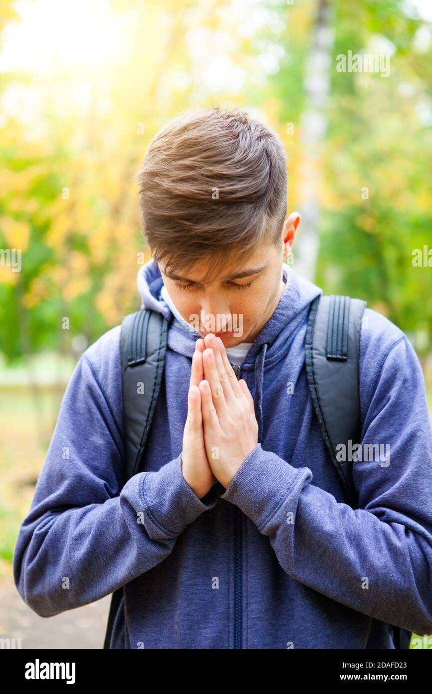 Young Man is Praying in the Autumn Forest Alone Stock Photo - Alamy