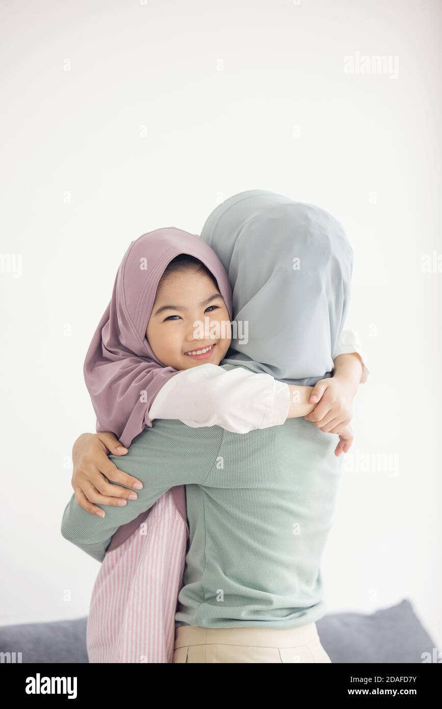Portrait of happy lovely family arabic muslim mother hug little ...