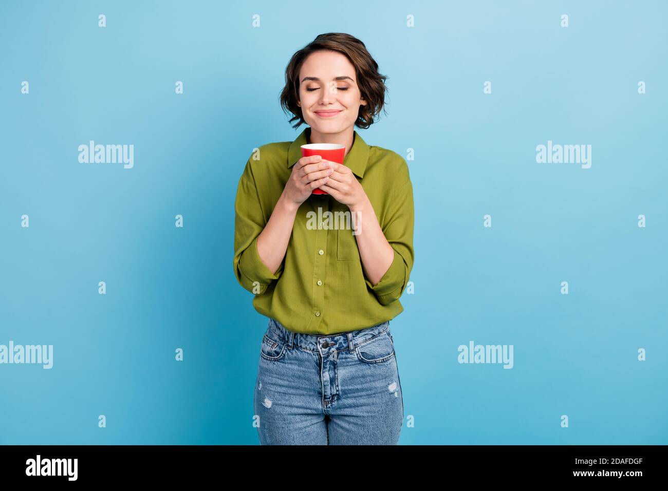 Photo of lovely lady short hairstyle hold mug close eyes sniff smell ...