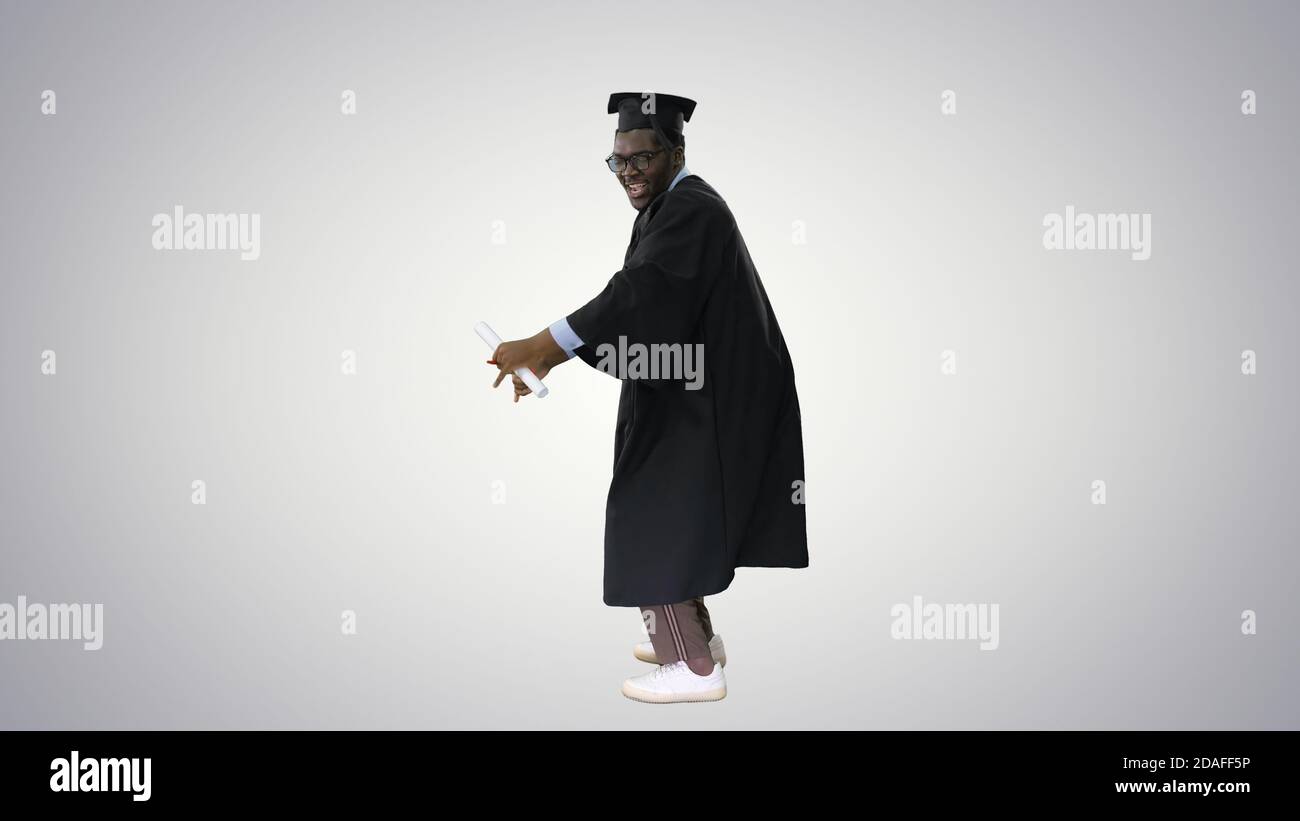 Excited african american male student in graduation robe dancing Stock ...