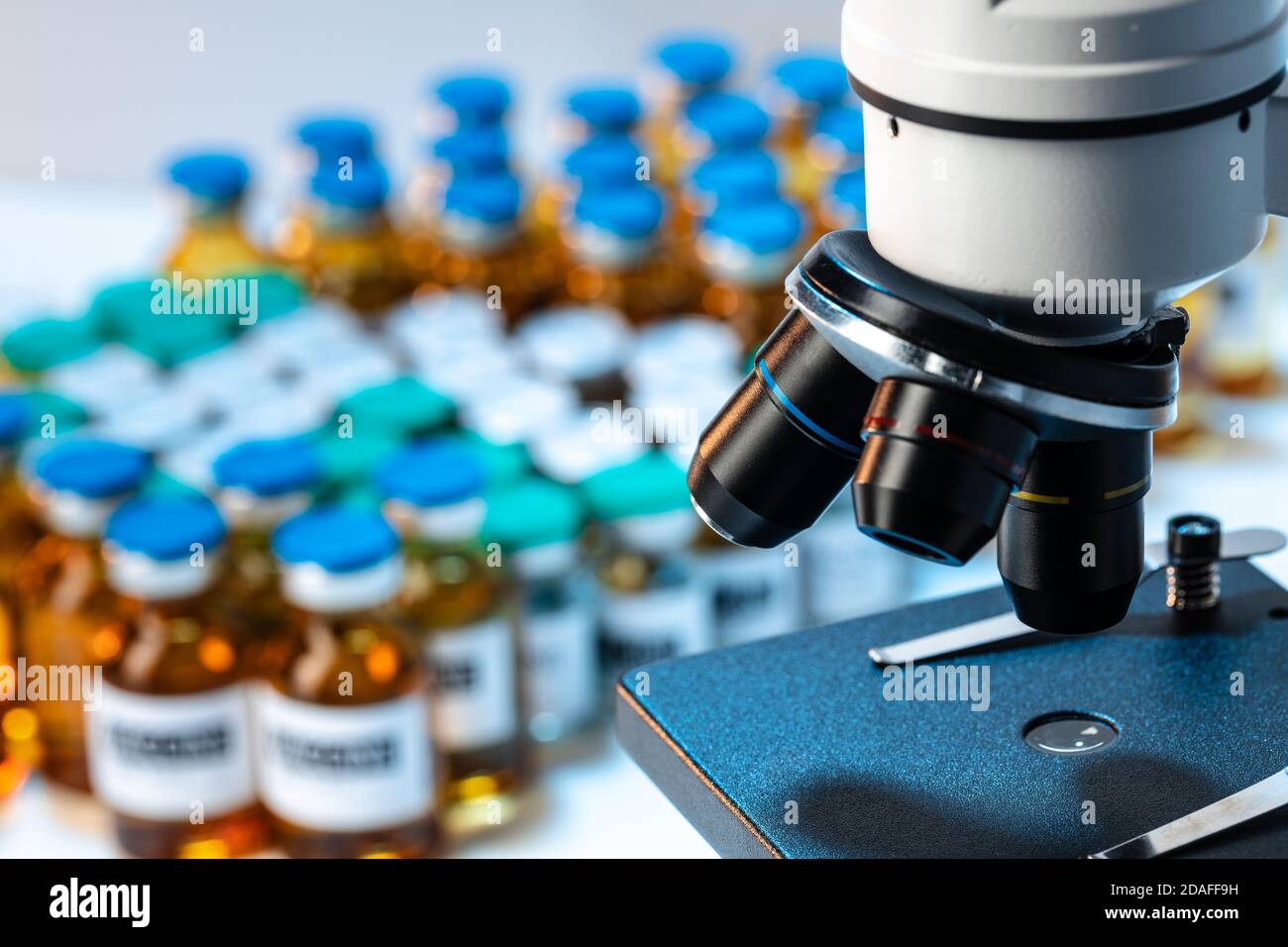 Medical vial with medication near microscope photo Stock Photo - Alamy