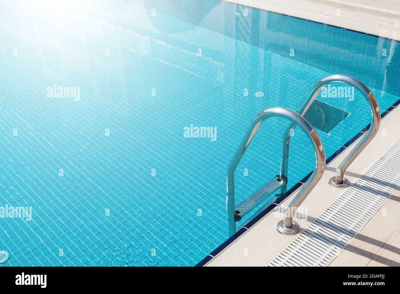 Sunny swimming pool in tropical resort. Summer vacation concept with ...