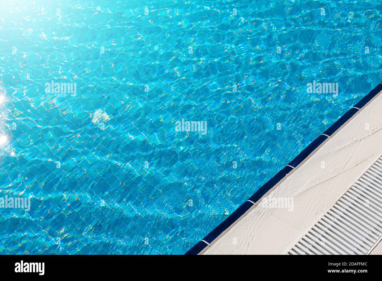 Sunny swimming pool in tropical resort. Summer vacation concept with ...