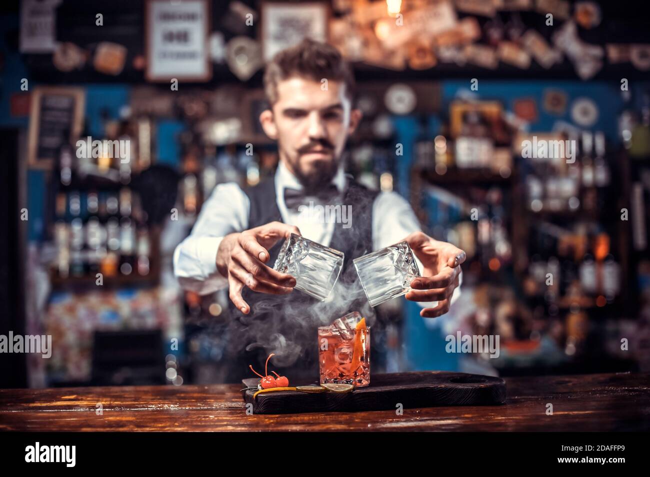 Confident bartender decorates colorful concoction in cocktail bars ...