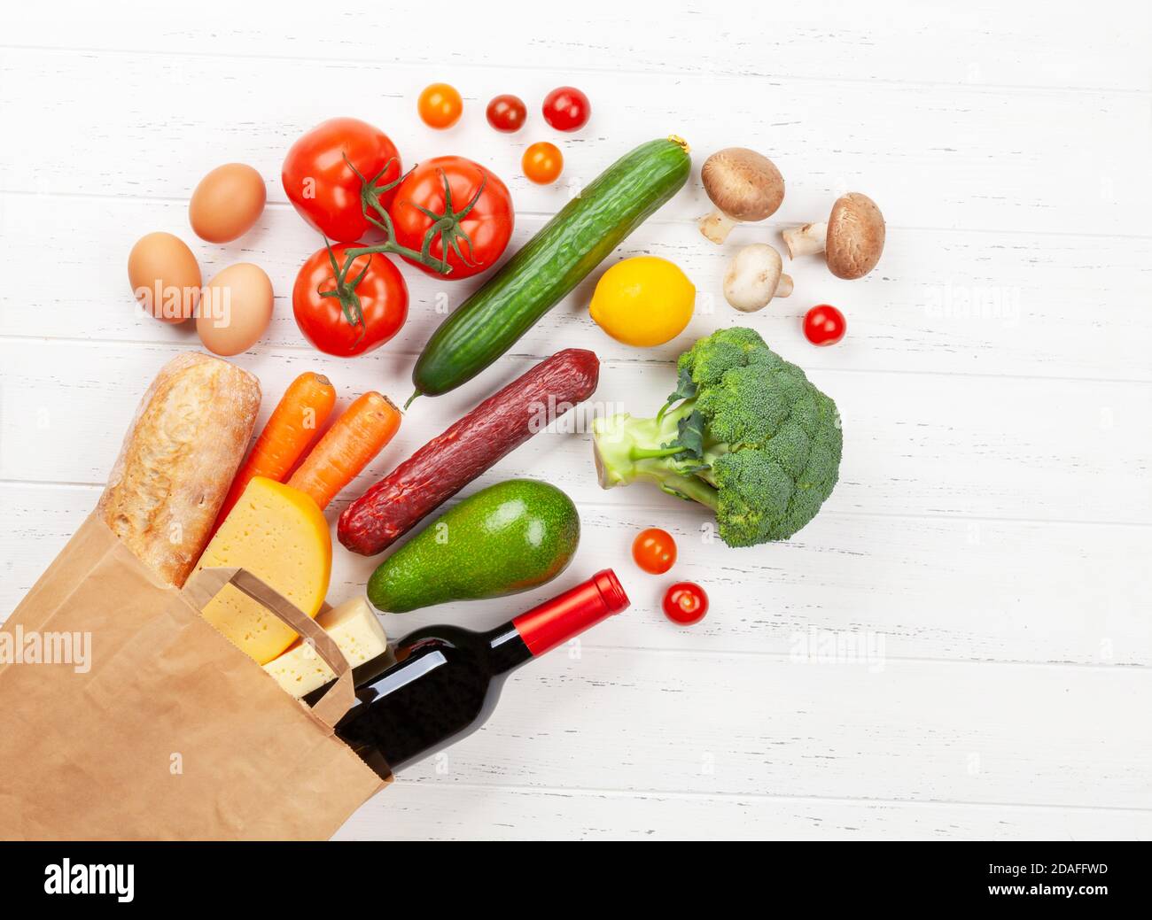 Different food in recycling paper bag on wooden table. Top view flat ...