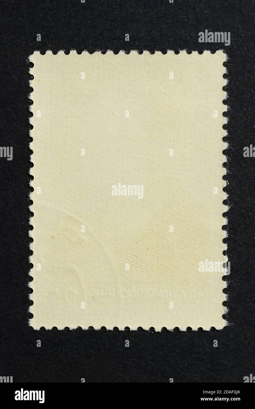 Blank vintage vertical postage stamp on black background. Mockup with ...