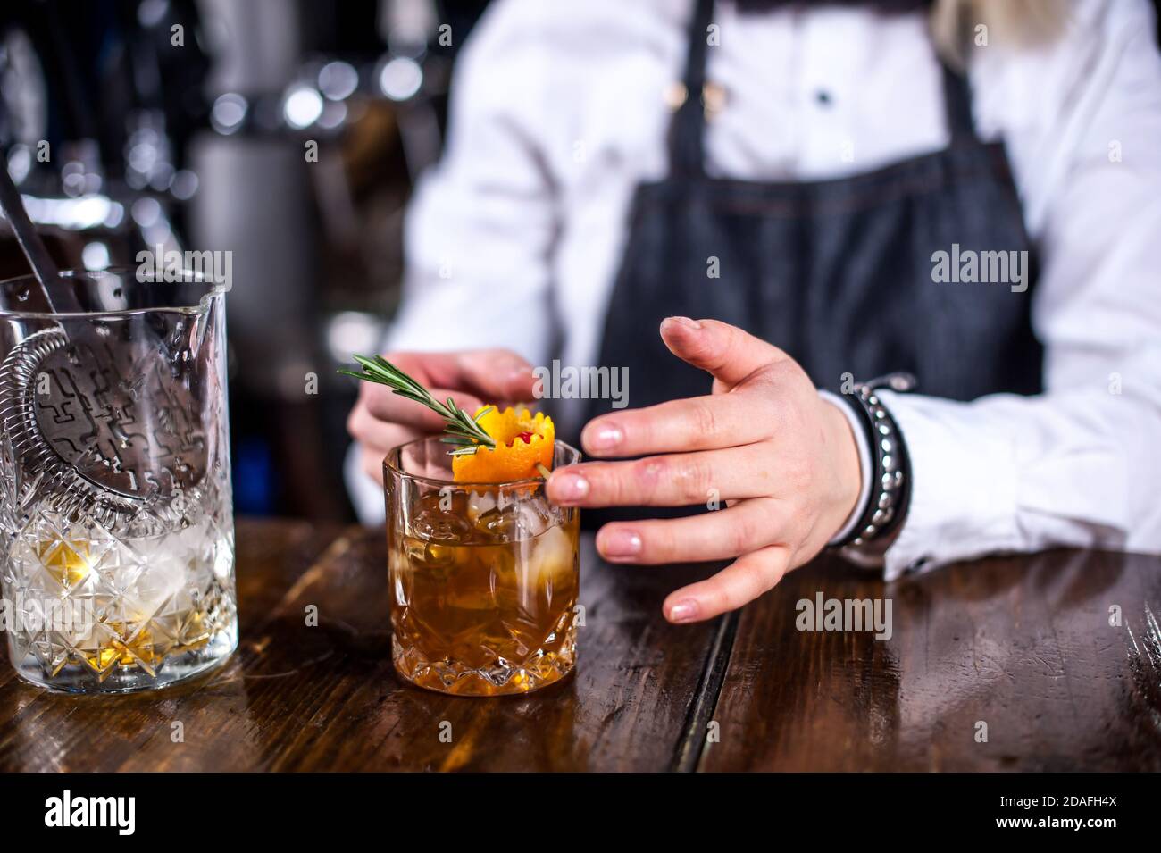 Charming girl barkeeper formulates a cocktail Stock Photo - Alamy